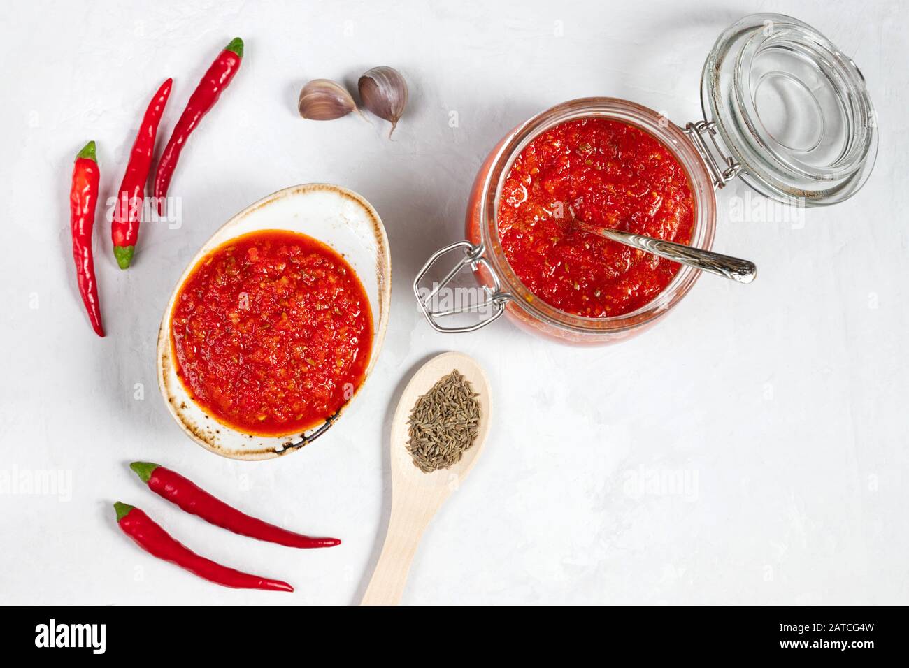 Hot chili pepper sauce paste harissa. Adjika on a white background ...