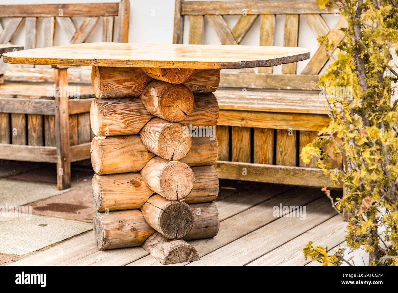 table with wooden logs in Italy Stock Photo - Alamy