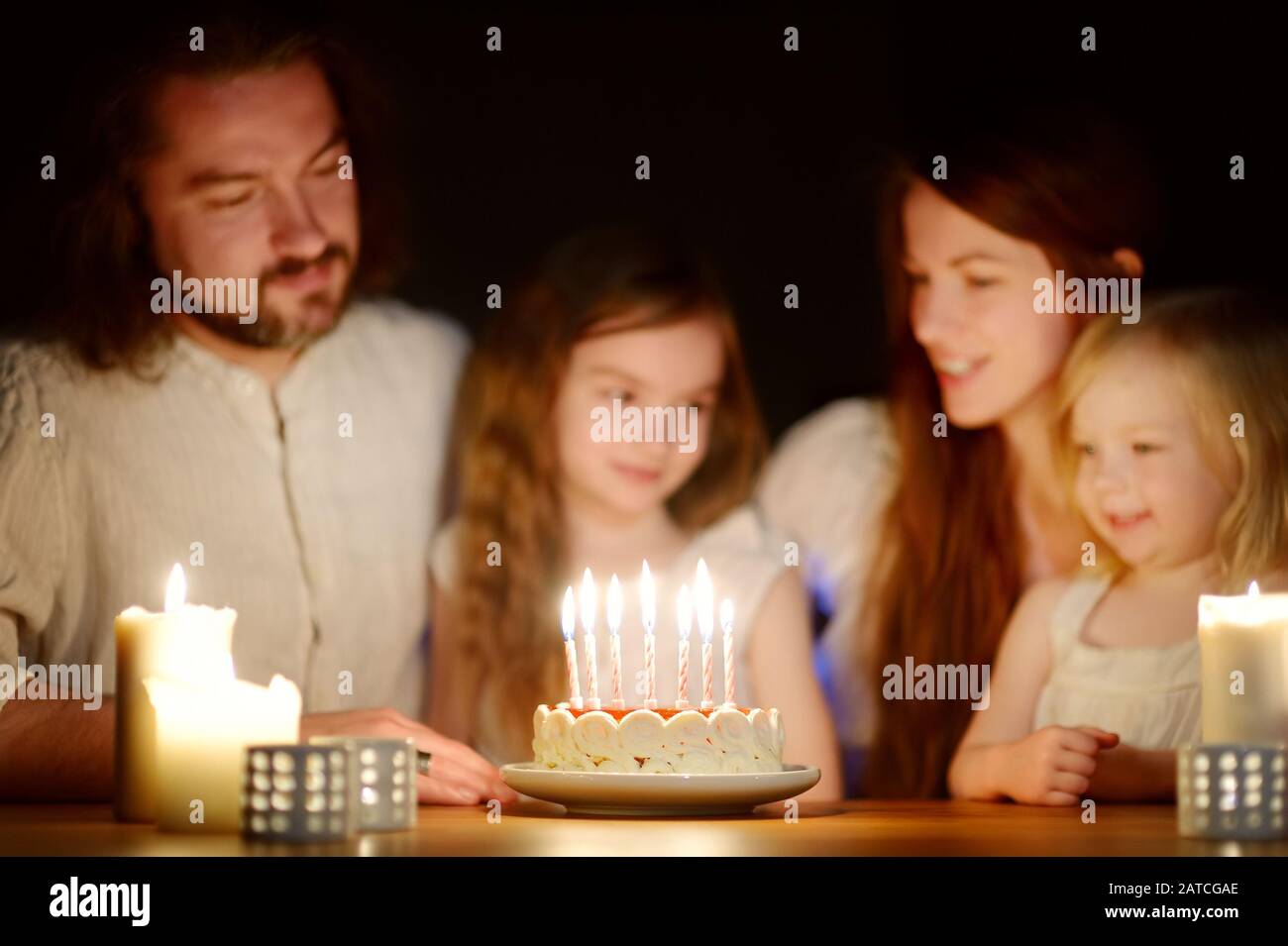 Cute Sever Year Old Girl Making A Wish Before Blowing Candles On Her