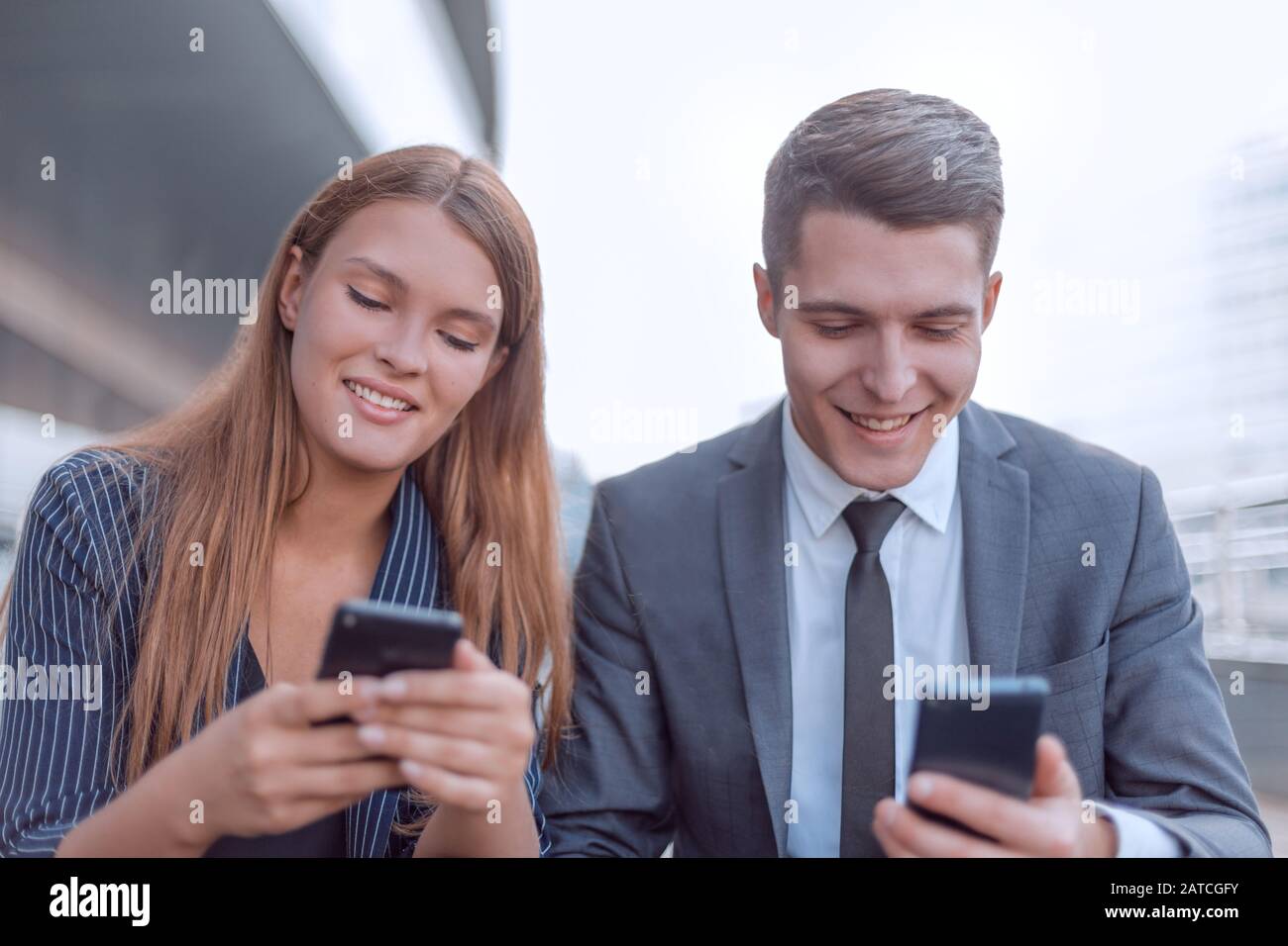 Young business couple smartphones hi-res stock photography and images - Alamy