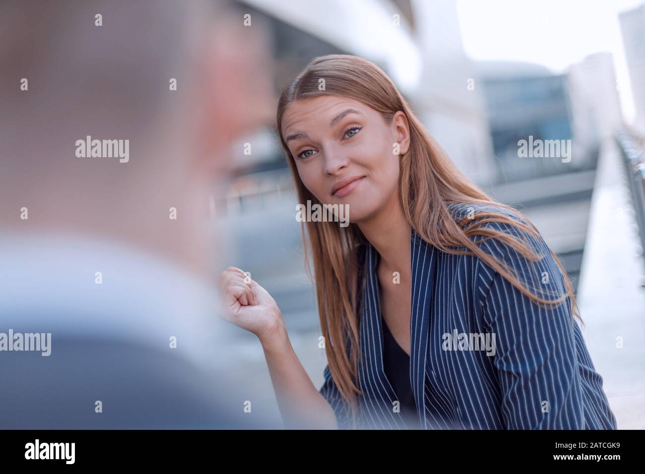 serious young woman asking something of her interlocutor Stock Photo ...