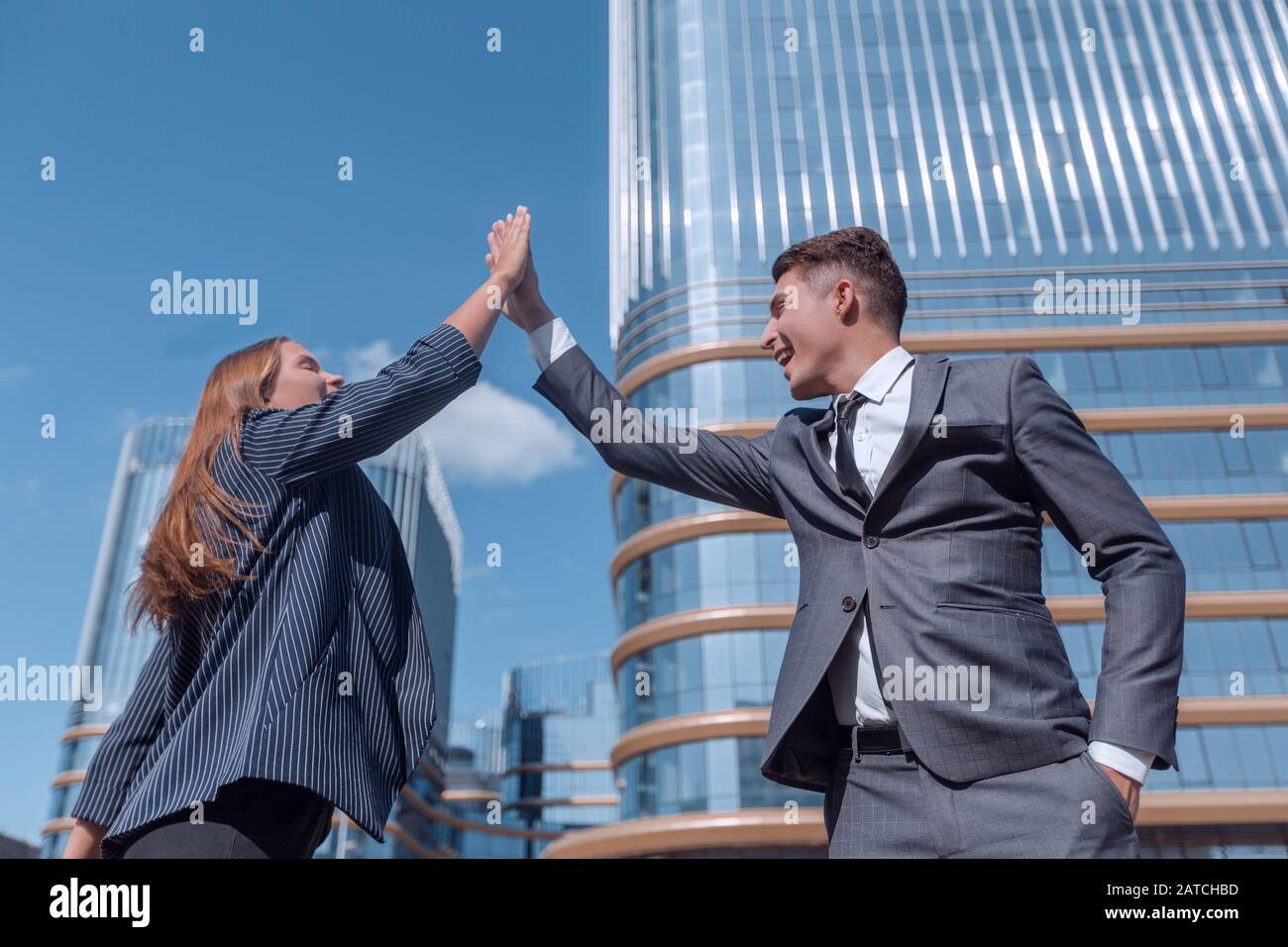 young business partners giving each other a high five Stock Photo - Alamy