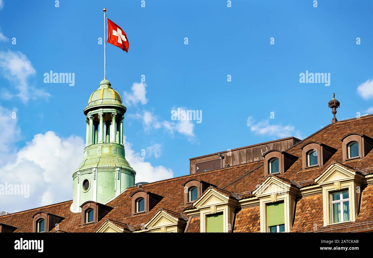 Tower with Swiss flag and roof covered with tiles Bern Stock Photo - Alamy