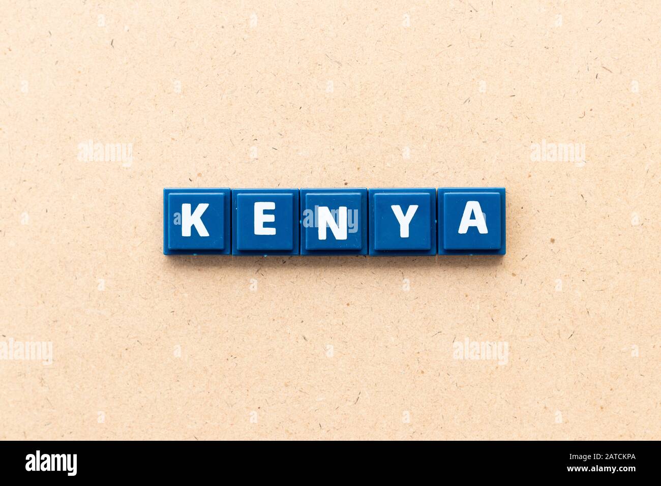 Tile letter in word Kenya on wood background Stock Photo - Alamy