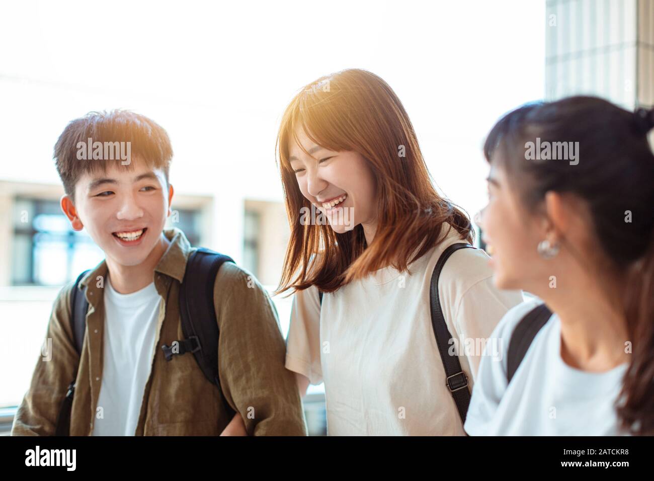 Group of happy students walking along the corridor at college Stock ...