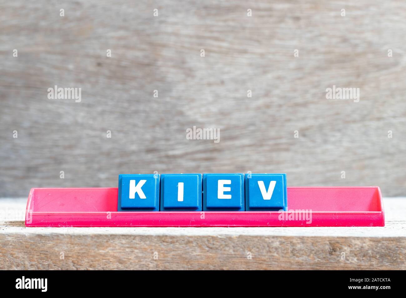 Tile letter on red rack in word Kiev on wood background Stock Photo - Alamy