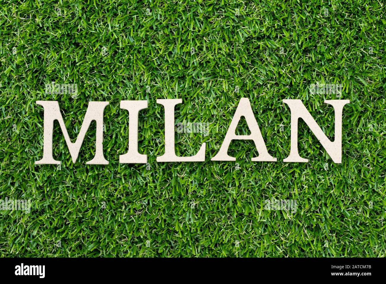 Wood alphabet letter in word Milan on green grass background Stock ...