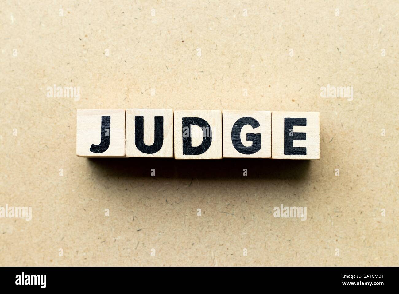 Letter block in word judge on wood background Stock Photo - Alamy