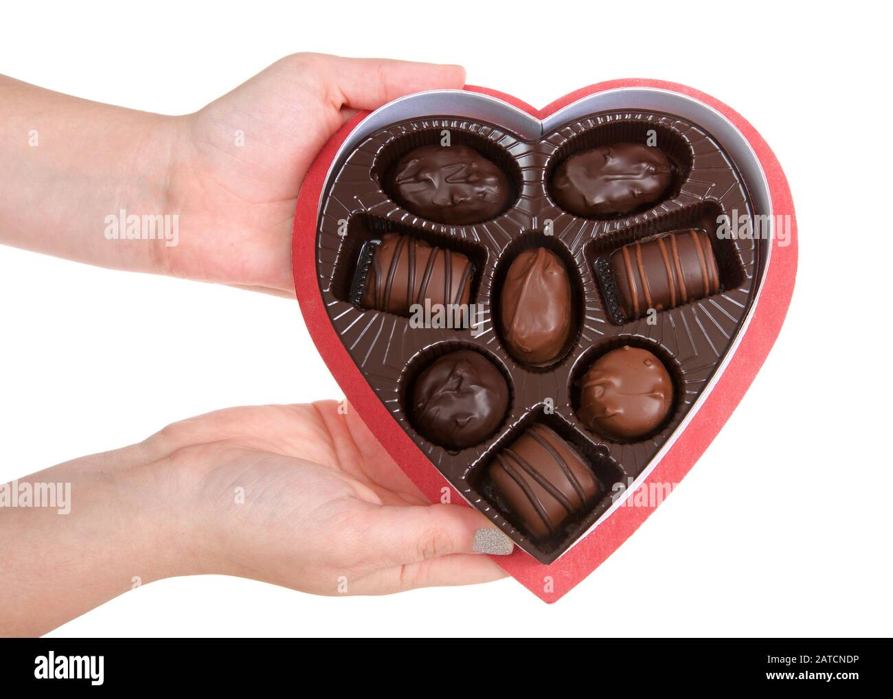 Hands holding Heart shaped box with chocolate candies isolated on white ...