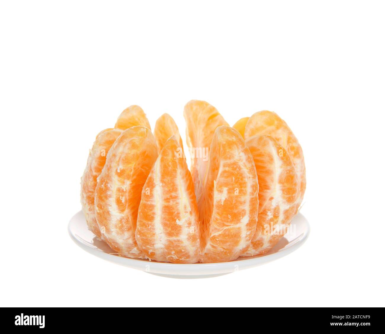 Whole sumo orange peeled and separated sitting on small round plate ...