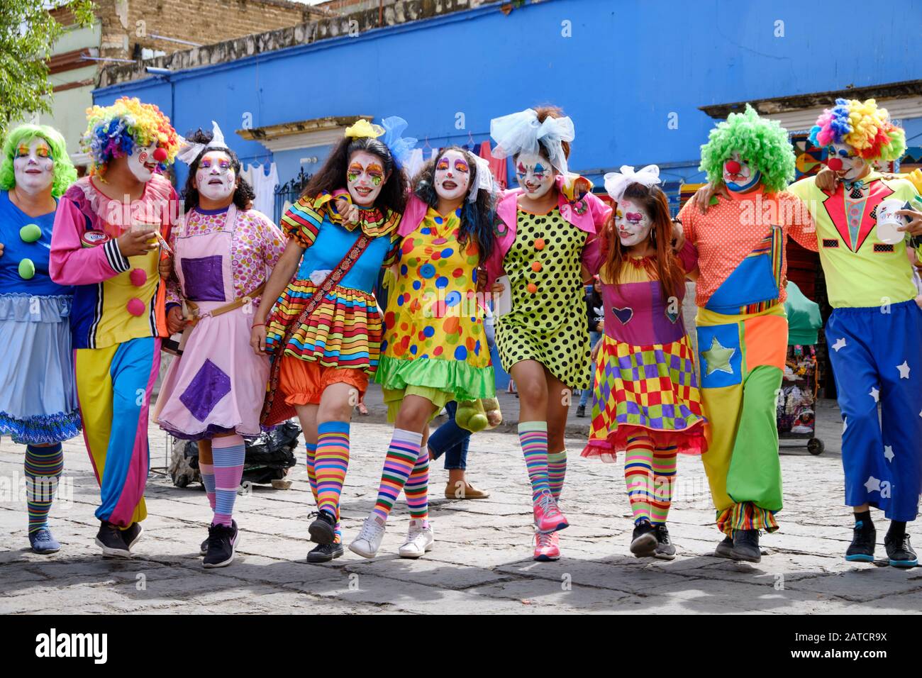 Line up of clowns doing leg up cancan dance in Oaxaca Stock Photo - Alamy