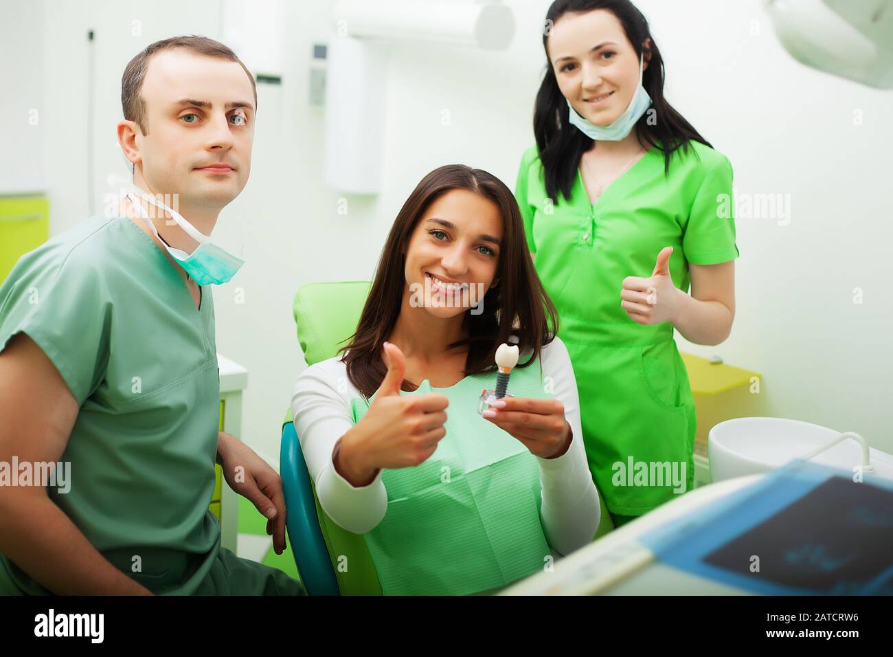 The dentist are treating teeth to client in dental office Stock Photo ...