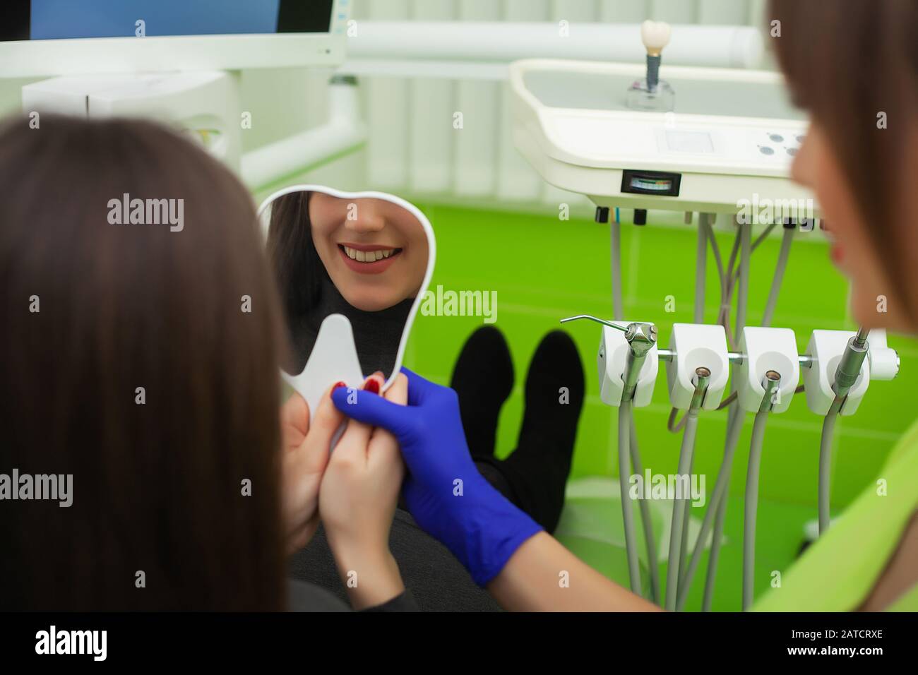The dentist are treating teeth to client in dental office Stock Photo ...