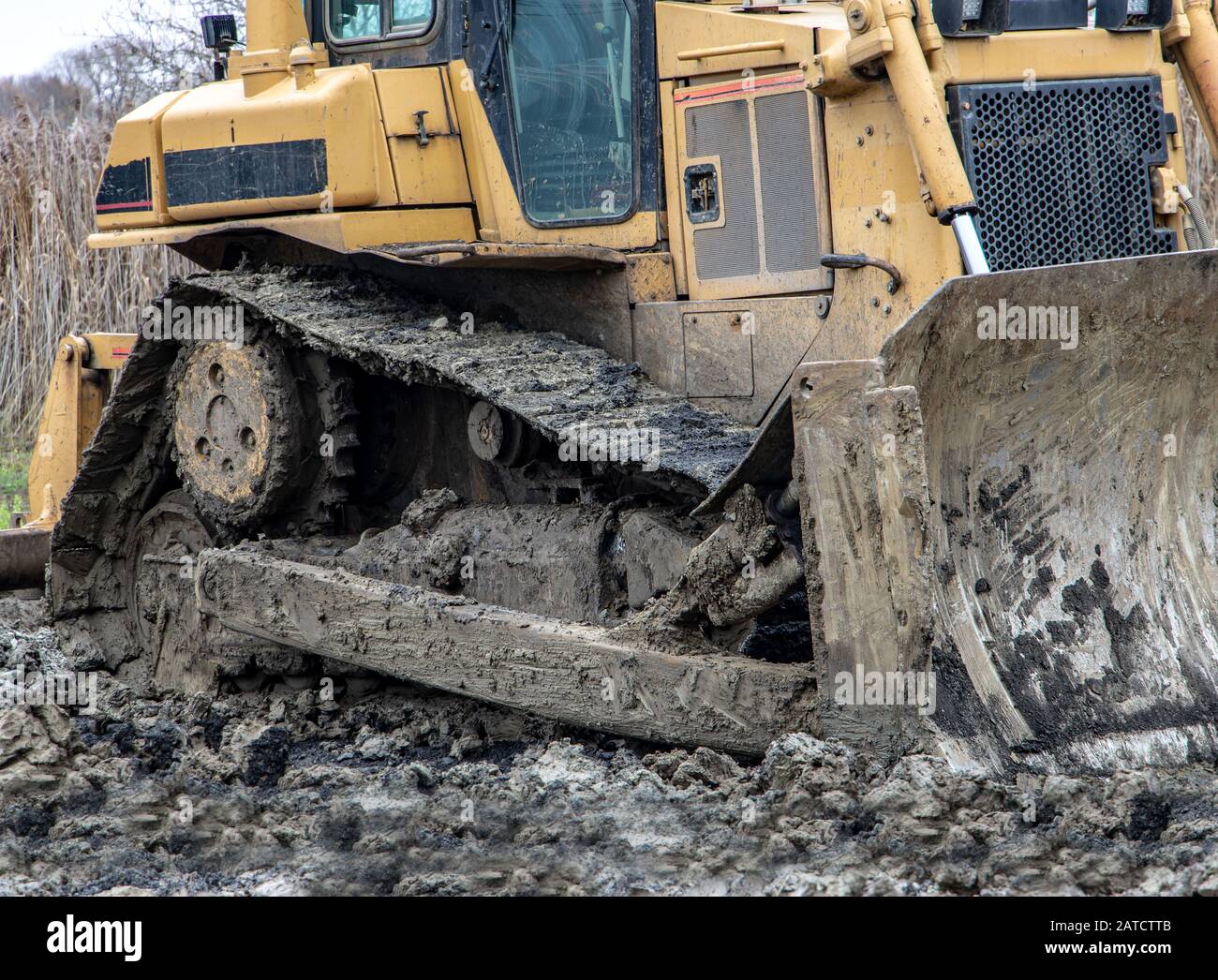 Dirty bulldozer standing in the mud. Autumn construction site with ...