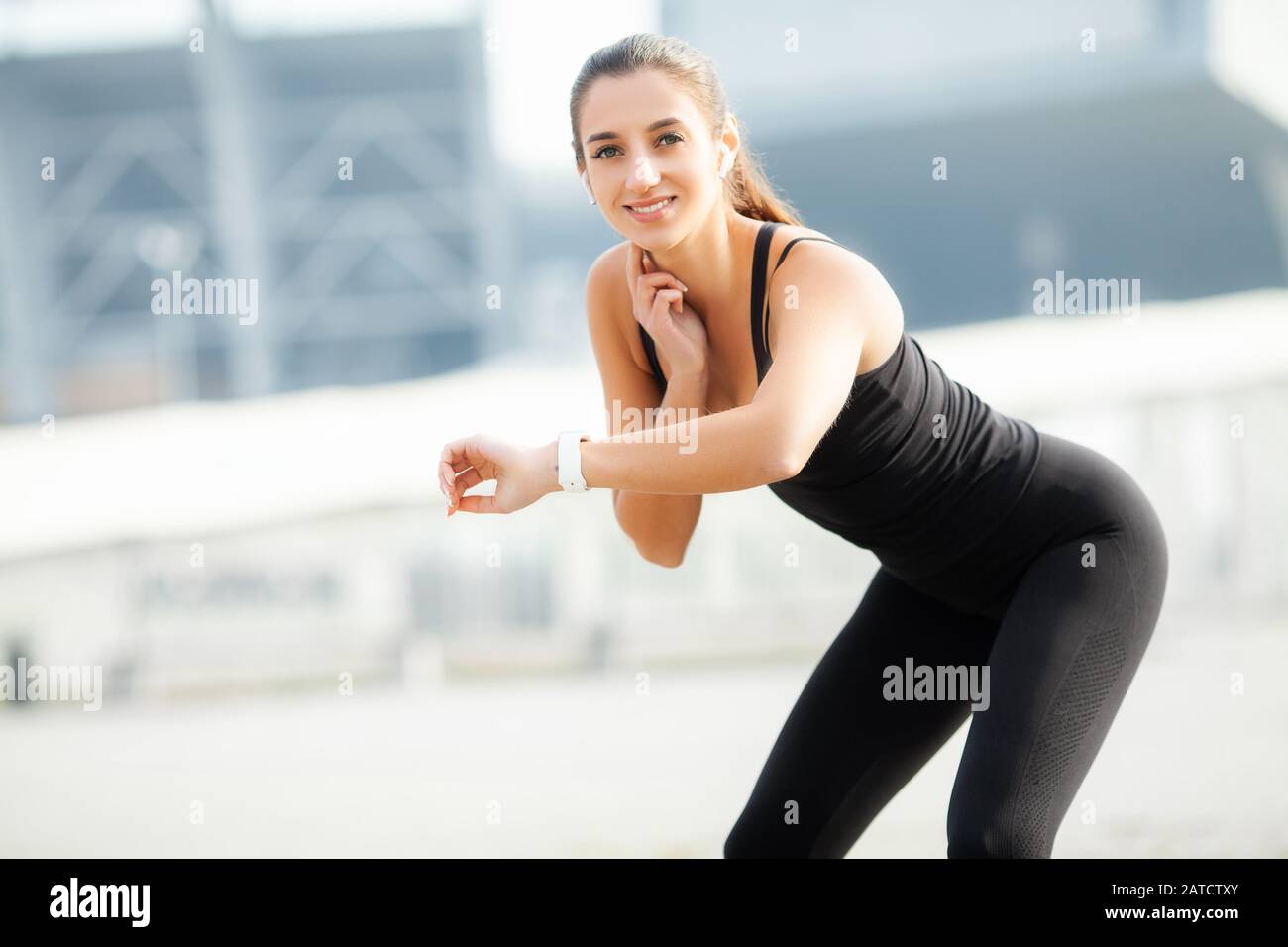 Fitness woman doing workout standing in a stadium background Stock ...