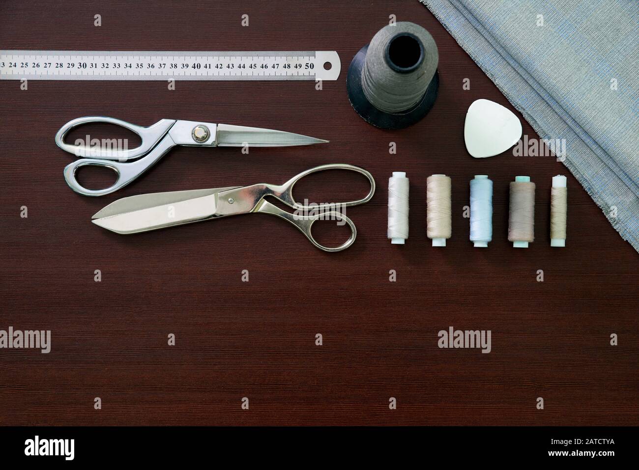 Group of sewing objects lying flat on a black chalkboard background ...