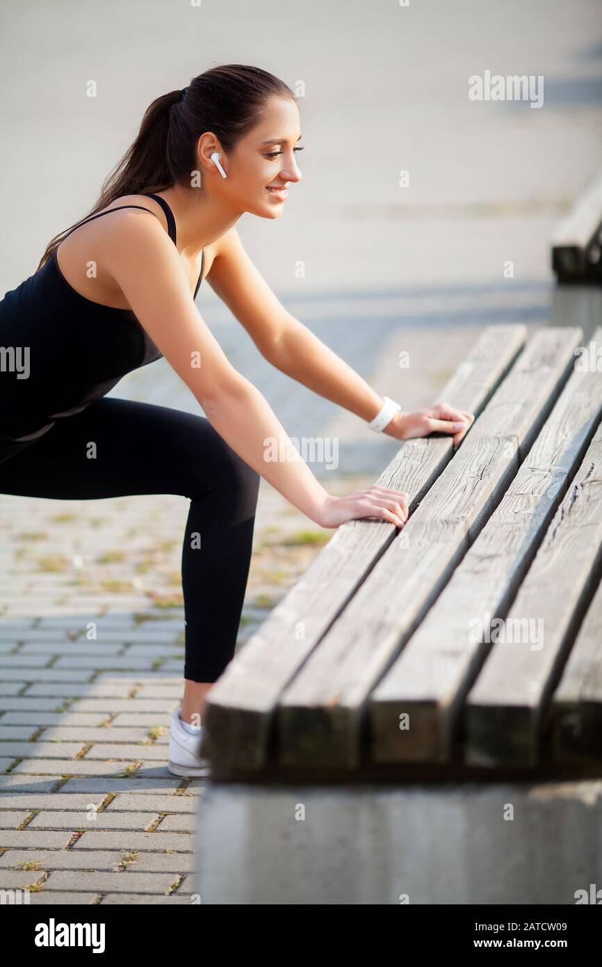 Fitness woman doing workout standing in a stadium background Stock ...