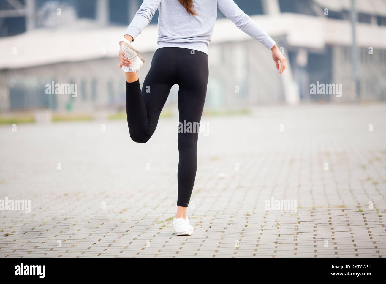Fitness woman doing workout standing in a stadium background Stock ...
