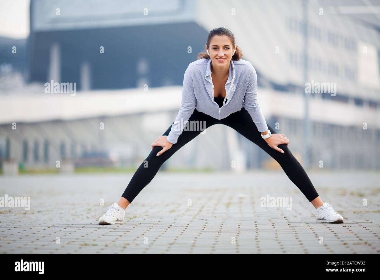 Fitness woman doing workout standing in a stadium background Stock ...