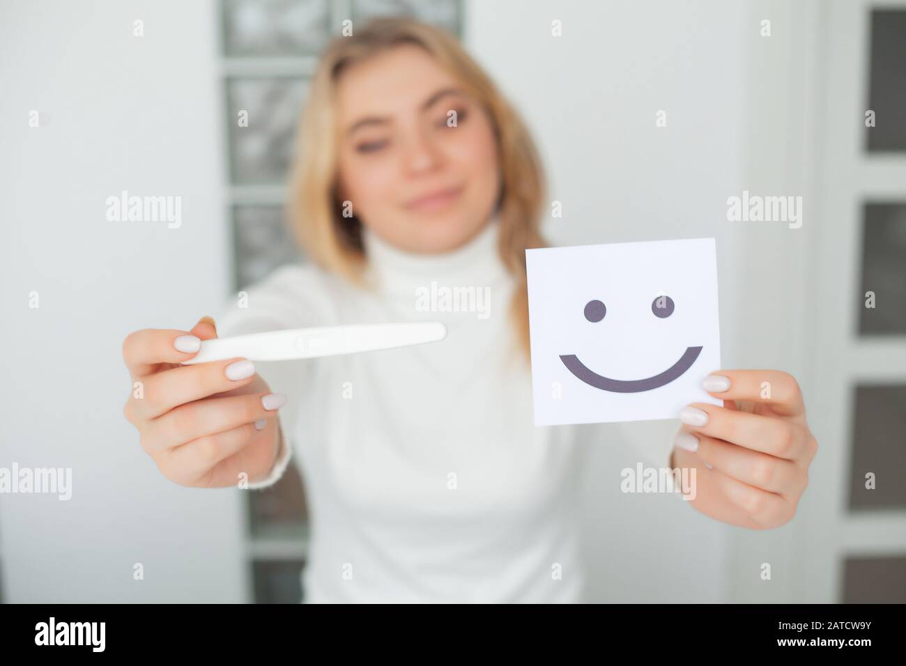 Happy woman Looking at a Pregnancy Test after result Stock Photo - Alamy