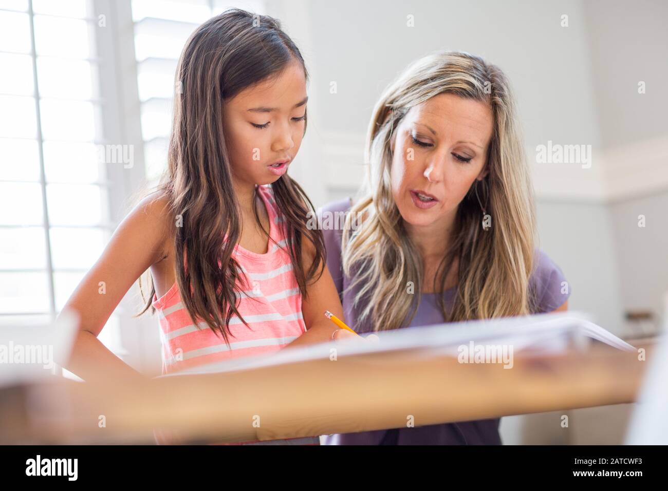 Teacher Helping Her Student With Her Homework Stock Photo - Alamy