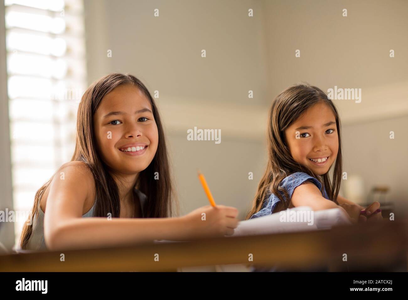 Young Girls Working On Their School Work Stock Photo - Alamy