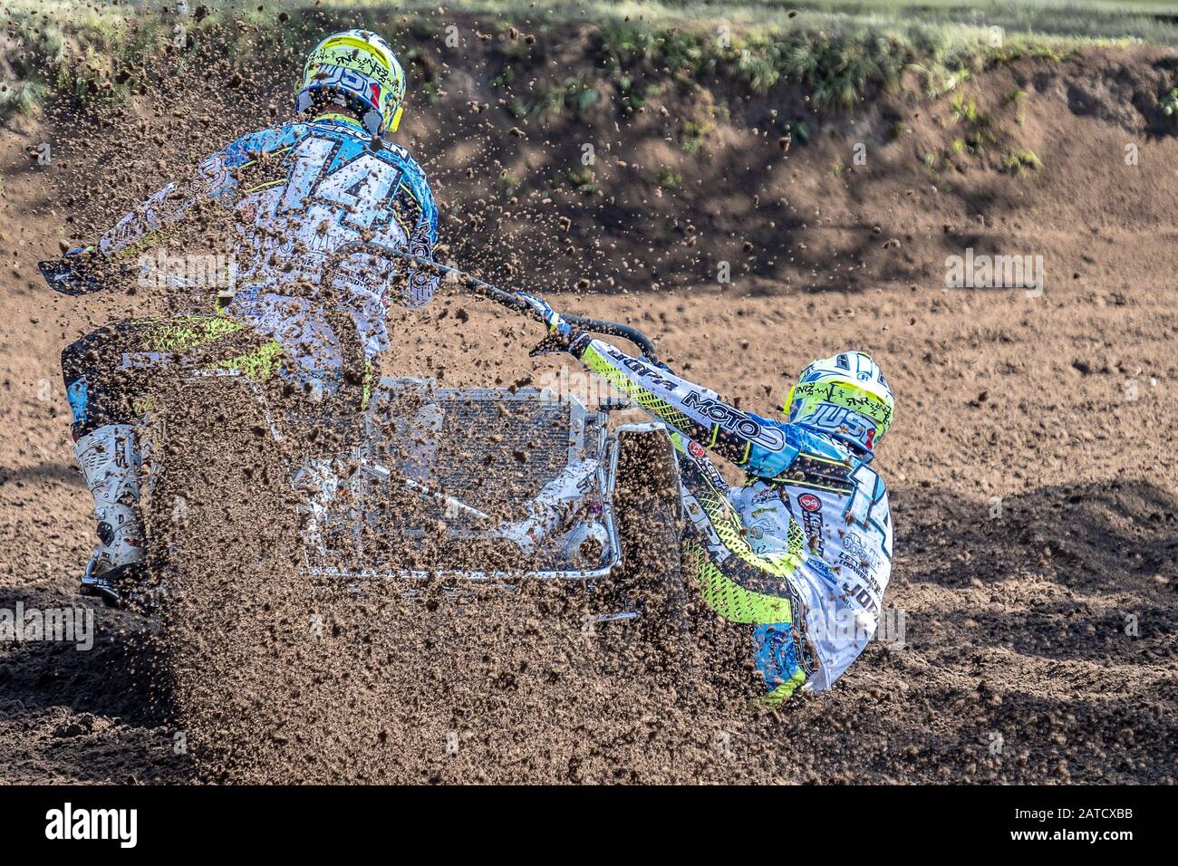 Great shot of two car racers wearing full gear in a muddy track Stock ...