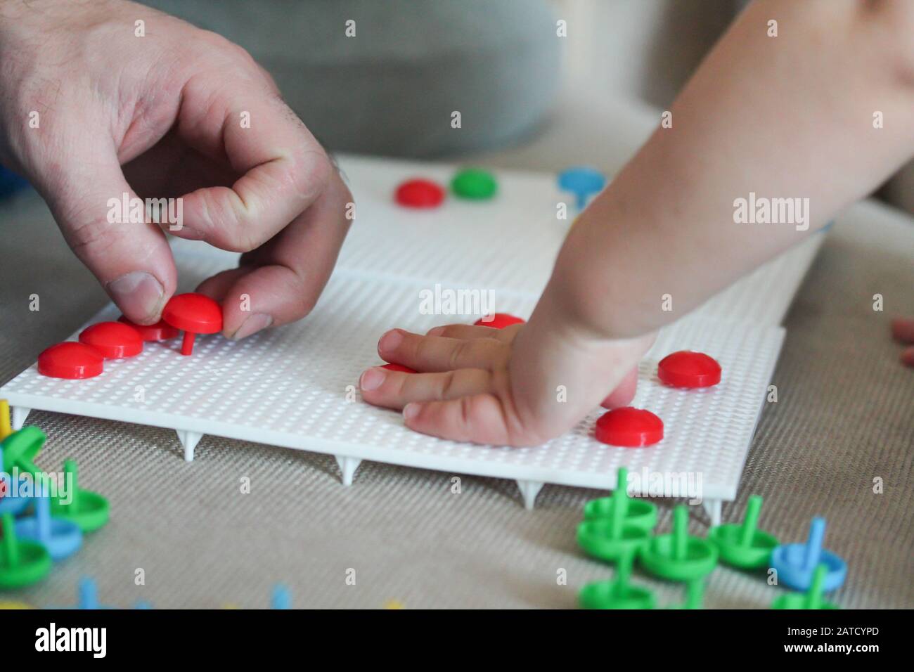Toddlers Playing With Pegboard