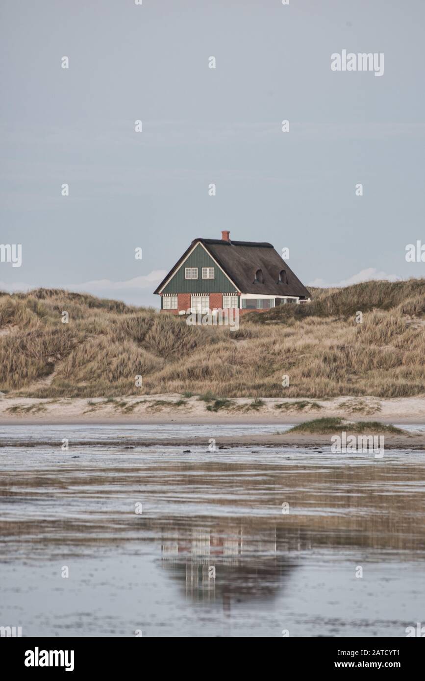 Vertical shot of a small isolated house on the shore of the sea Stock ...