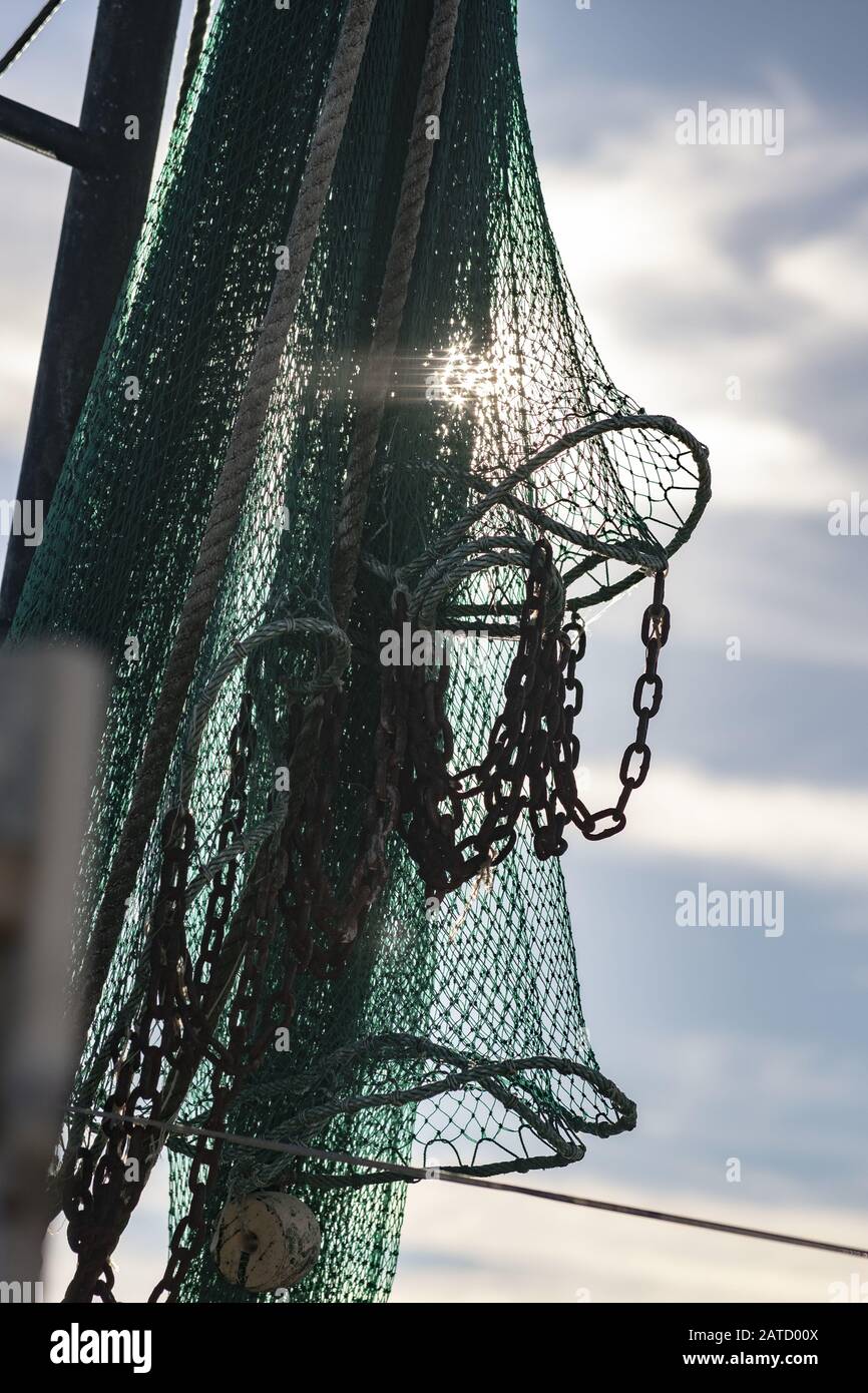 Vertical closeup shot of fishing nets and the cloudy sky in the ...