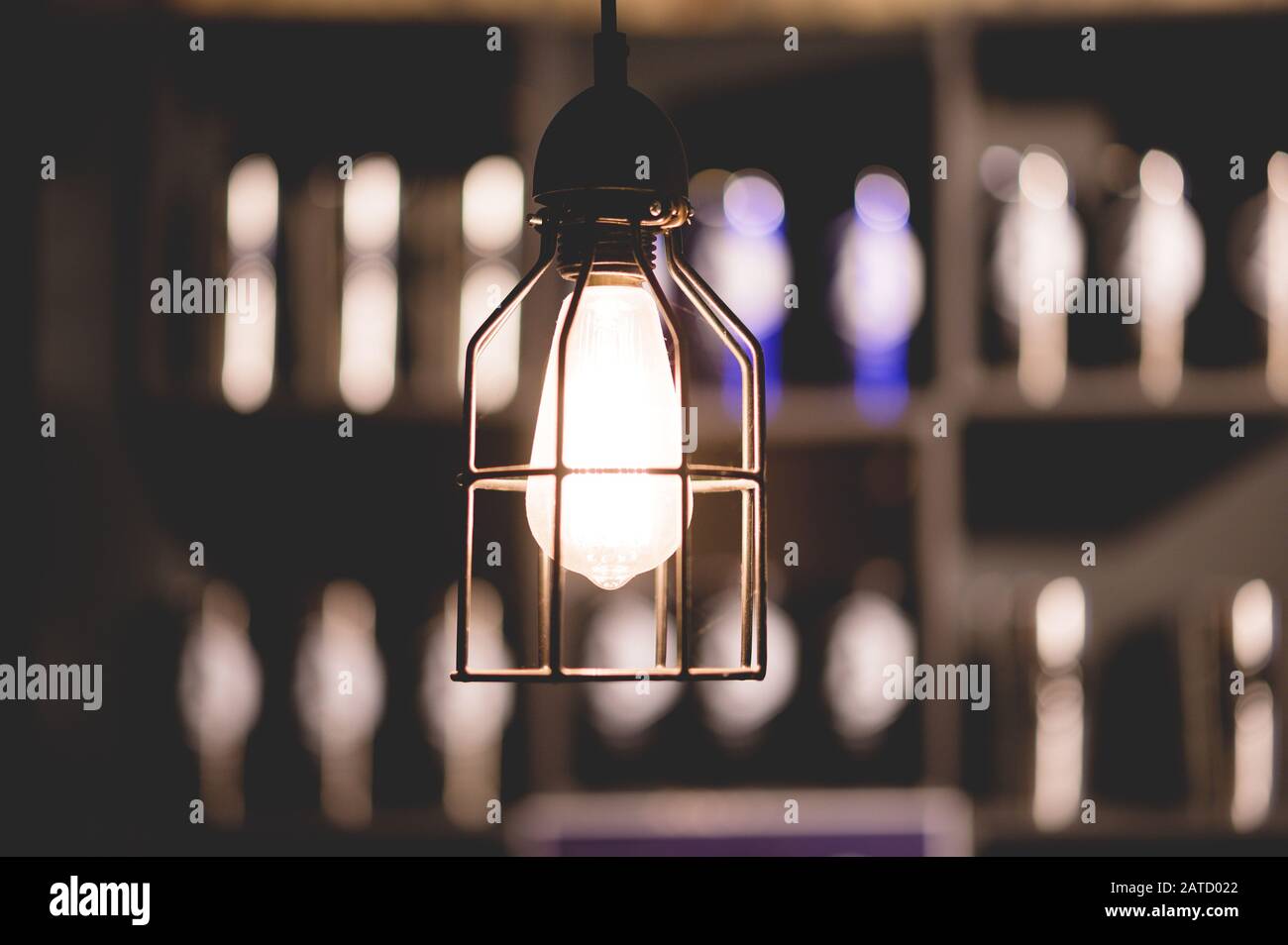 Hanging turned on lamp with blurred background Stock Photo - Alamy