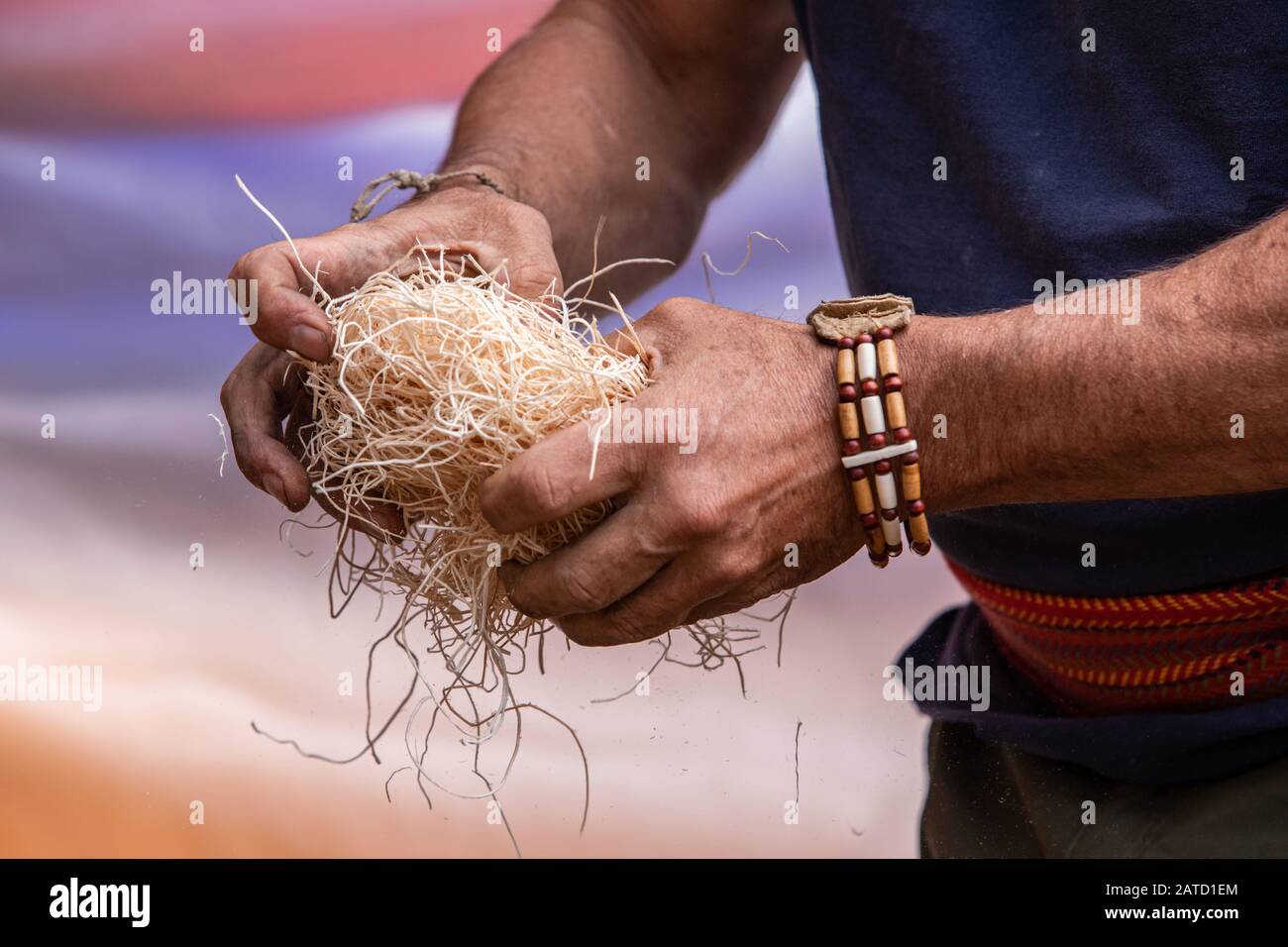 Closeup of man hand holding straws to light fire during a demonstration ...