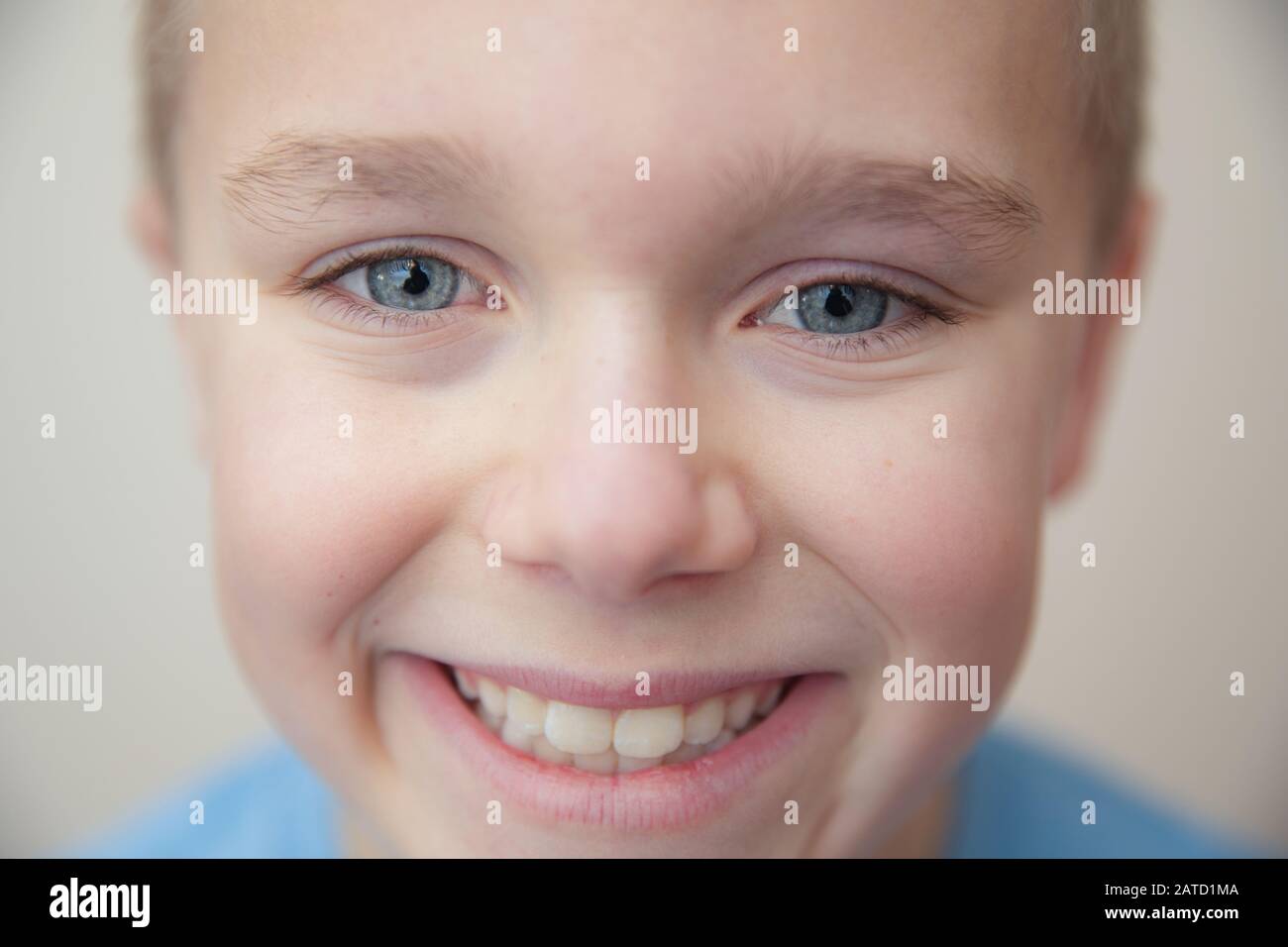 Happy young boy smiling at the camera Stock Photo - Alamy