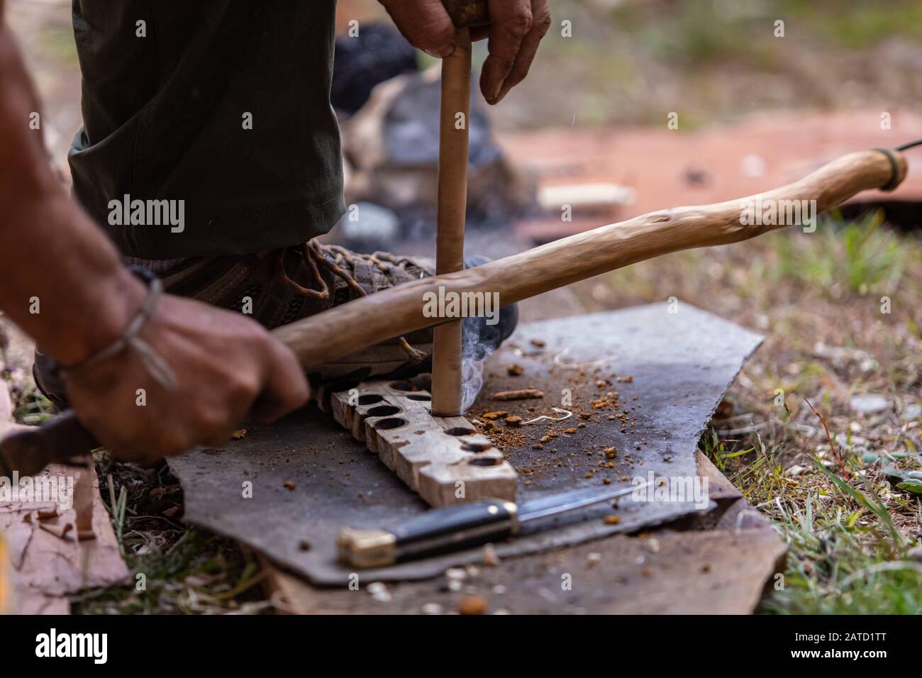 Closeup of man demonstrating lighting of fire using traditional native ...