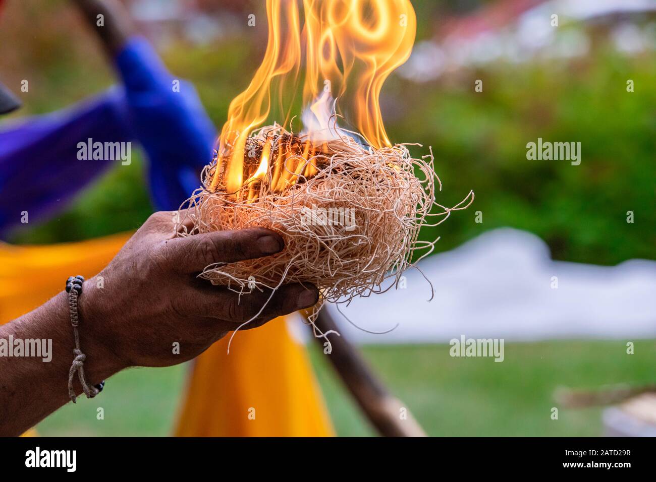 Closeup of man with dirty hands carrying burning fire during ...