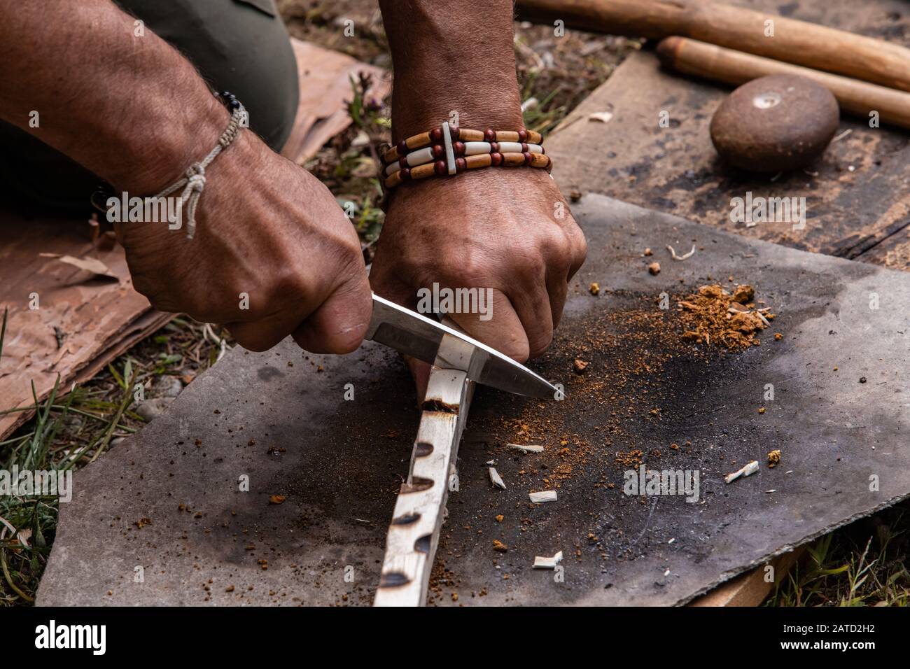 Closeup image of hands of a young man giving demonstration of a native ...