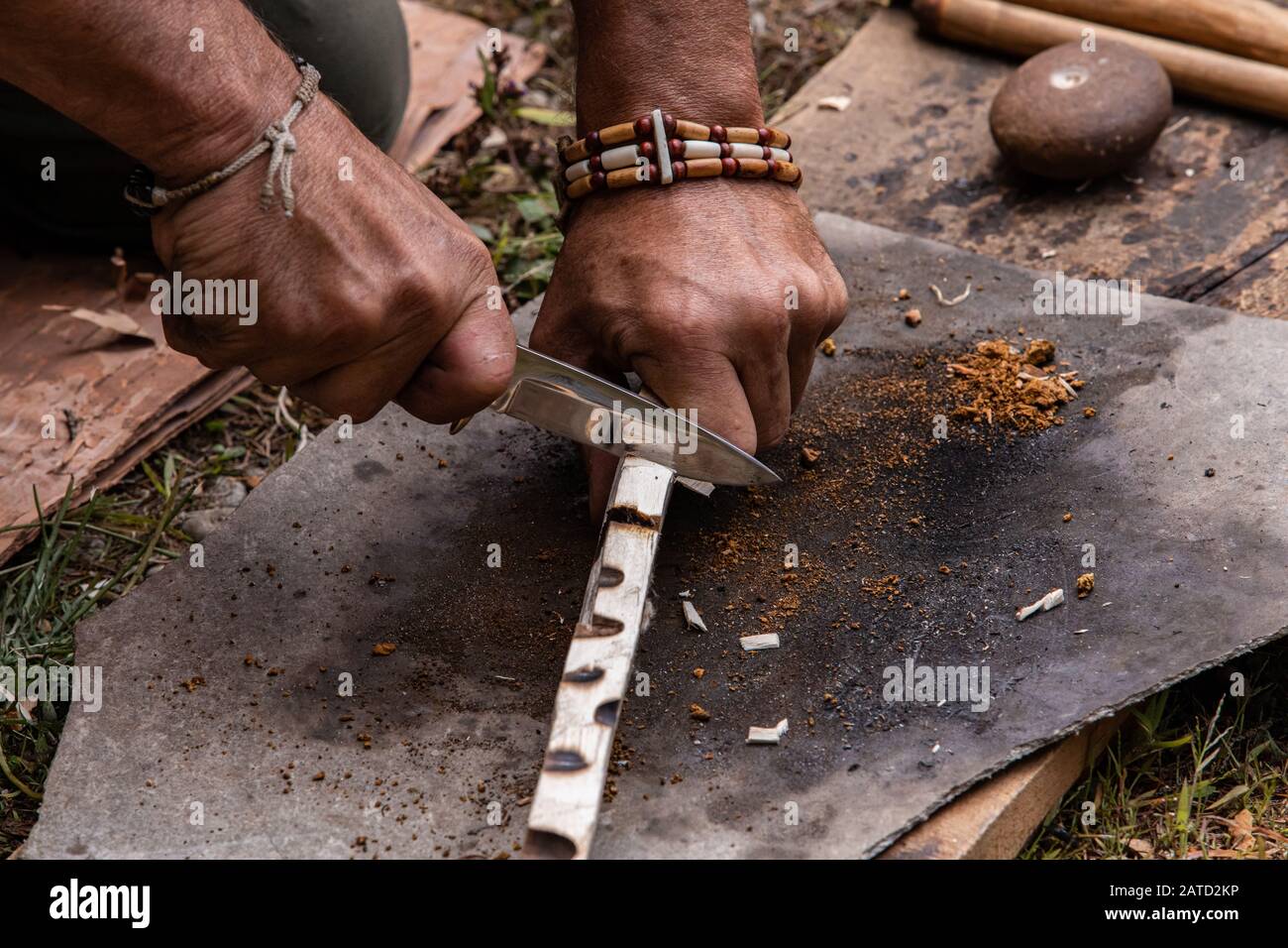 Closeup image of cropped hands man demonstrating a native traditional ...