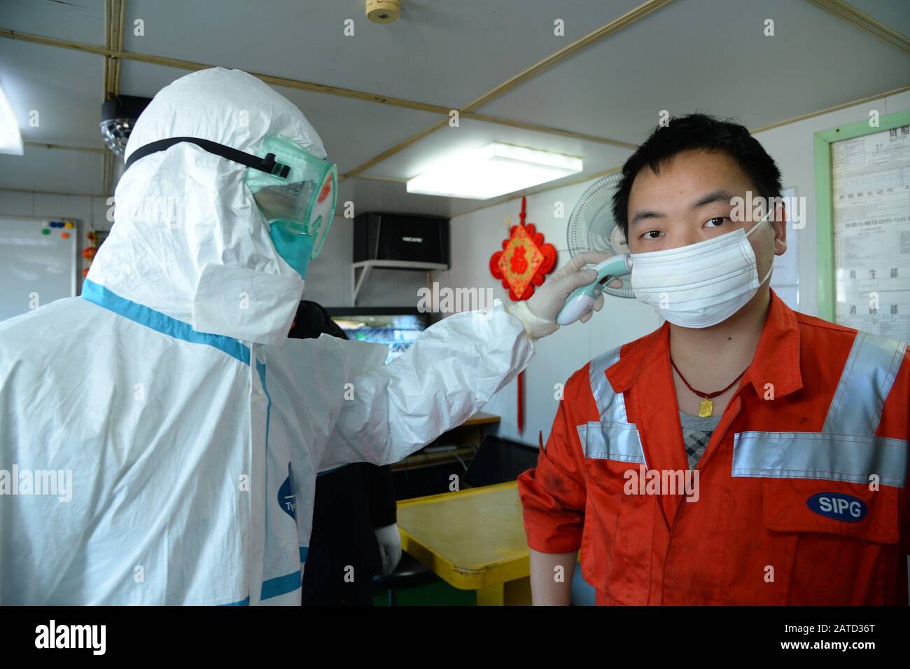 Chinese customs officers wearing protective clothing for prevention of ...