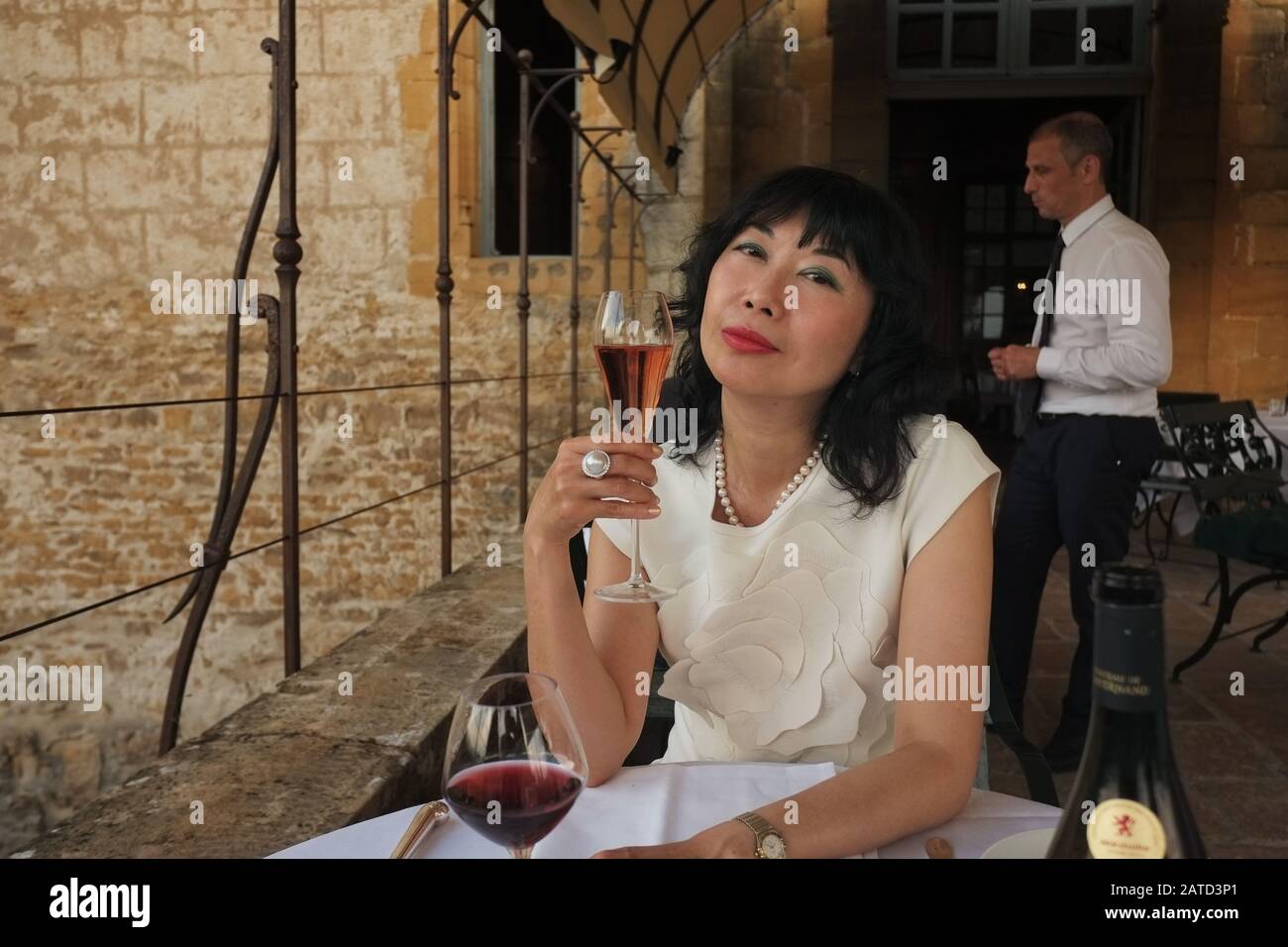 A glamorous woman drinking a glass of French champagne from the ...
