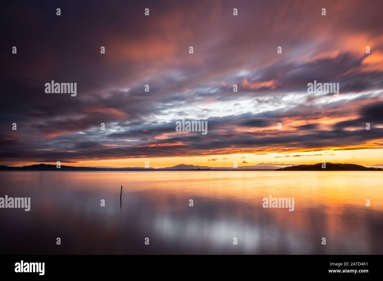 Sunset a Trasimeno lake (Umbria, Italy), with fishing net poles and ...