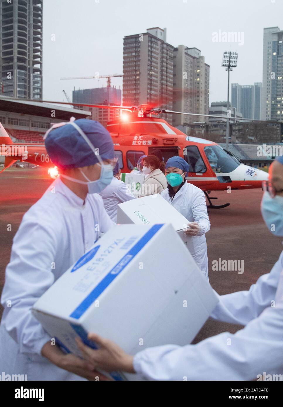 Chinese medical workers pass on cartons of medical materials delivered ...