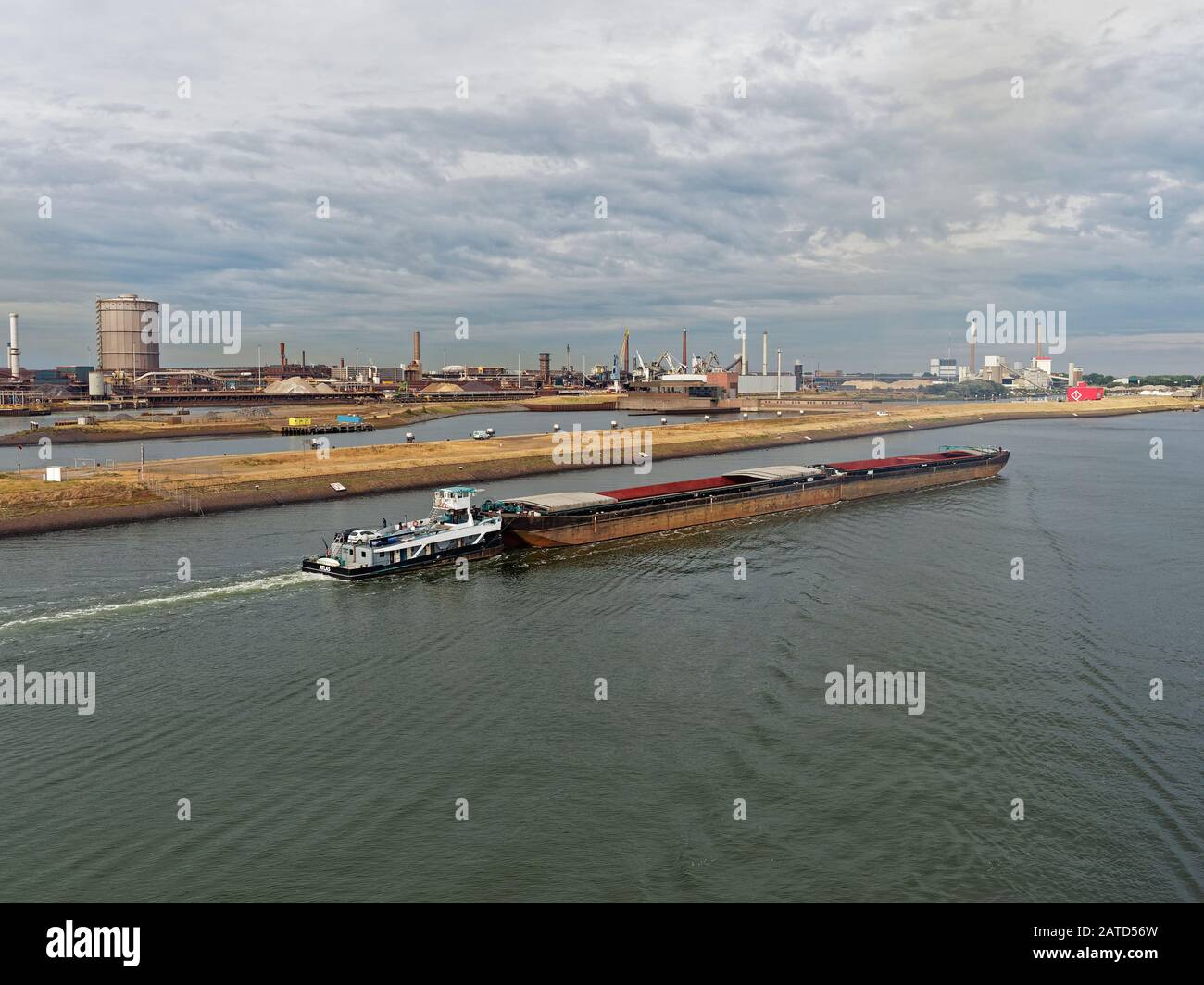 The Atlas, a Dutch River tug pushing its empty barge Containers up the ...