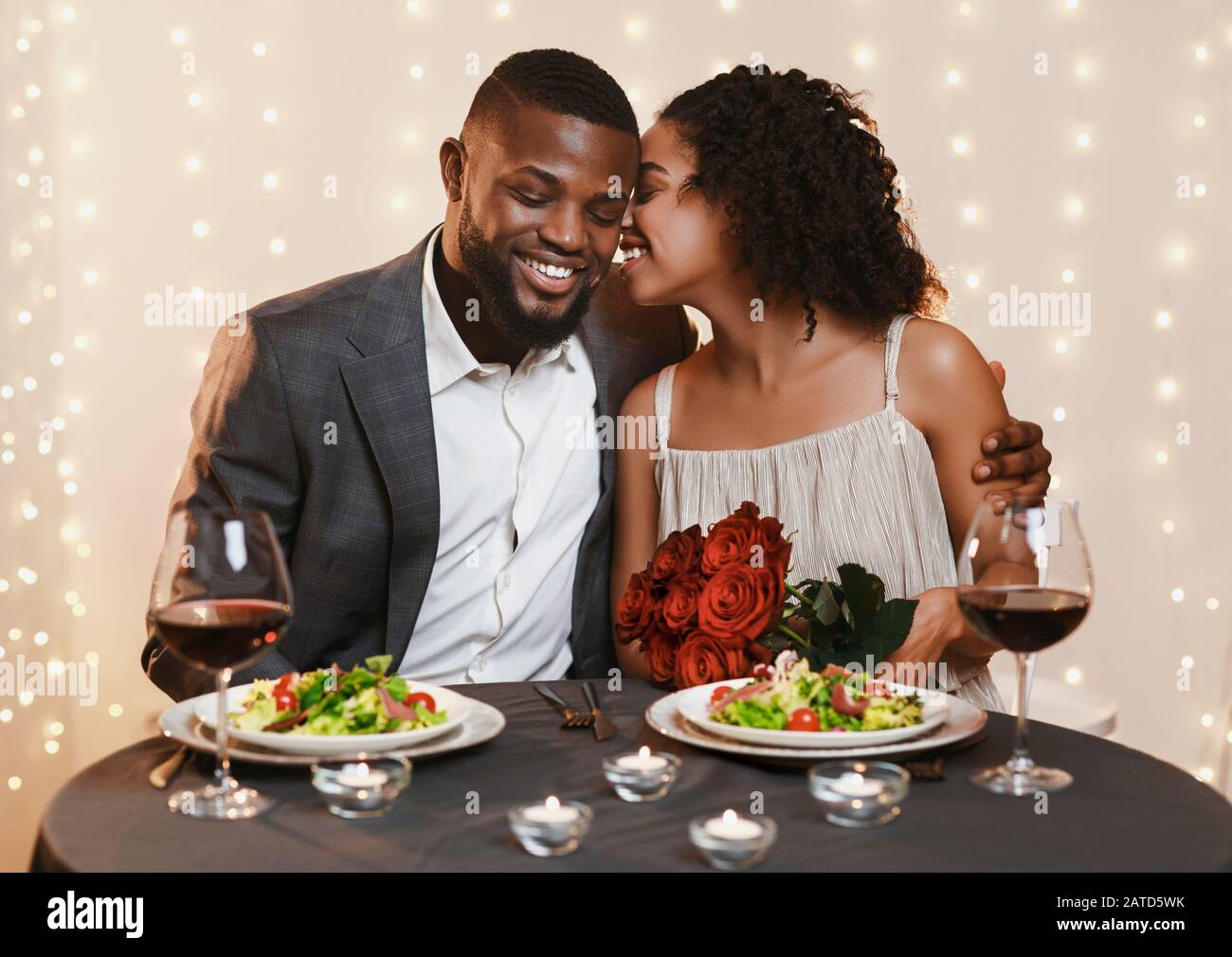 Thankful black lady kissing her boyfriend, restaurant interior Stock ...