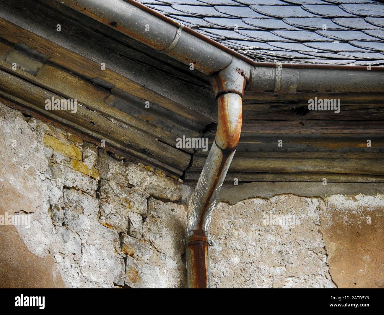 Rusty old gutter in front of an old facade Stock Photo - Alamy