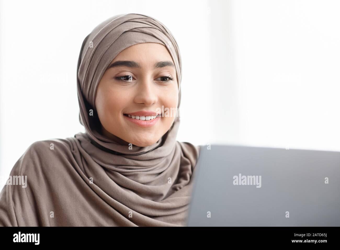 Young Muslim Girl Job Seeker In Hijab Looking At Laptop Screen Stock ...