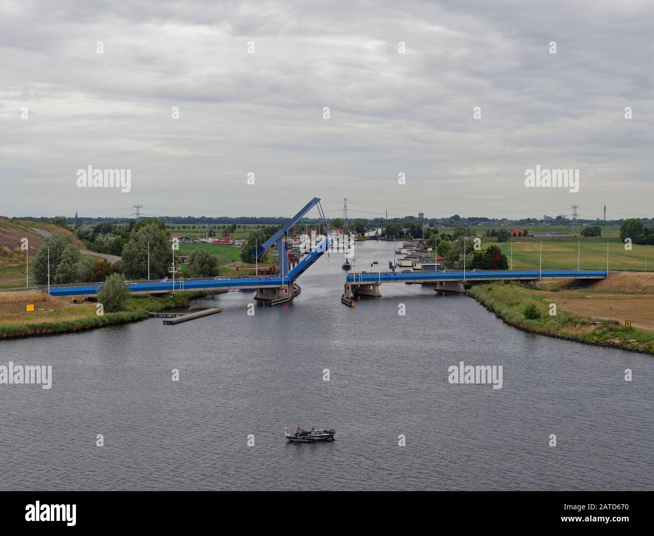 A modern cantilever Bridge opening to allow a sailing Vessel to move ...