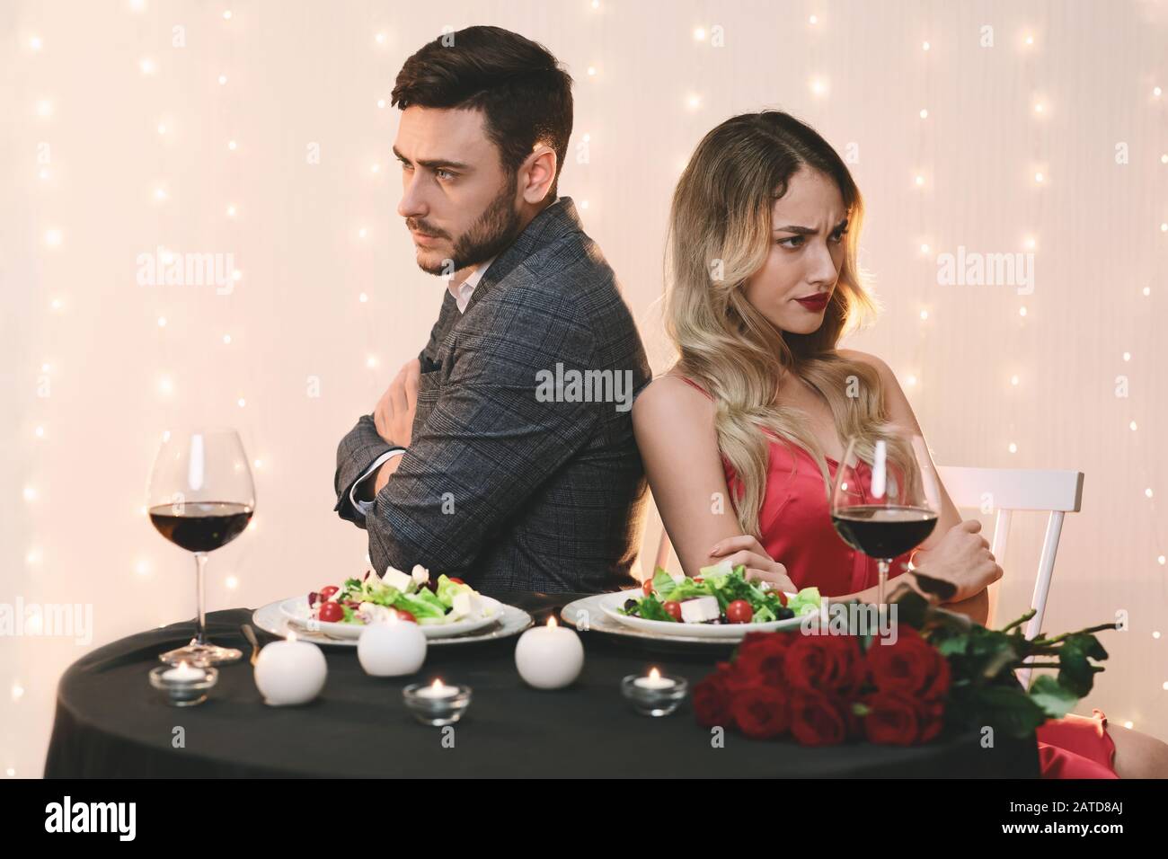 Millennial Couple Sitting Back To Back After Arguing In Restaurant ...