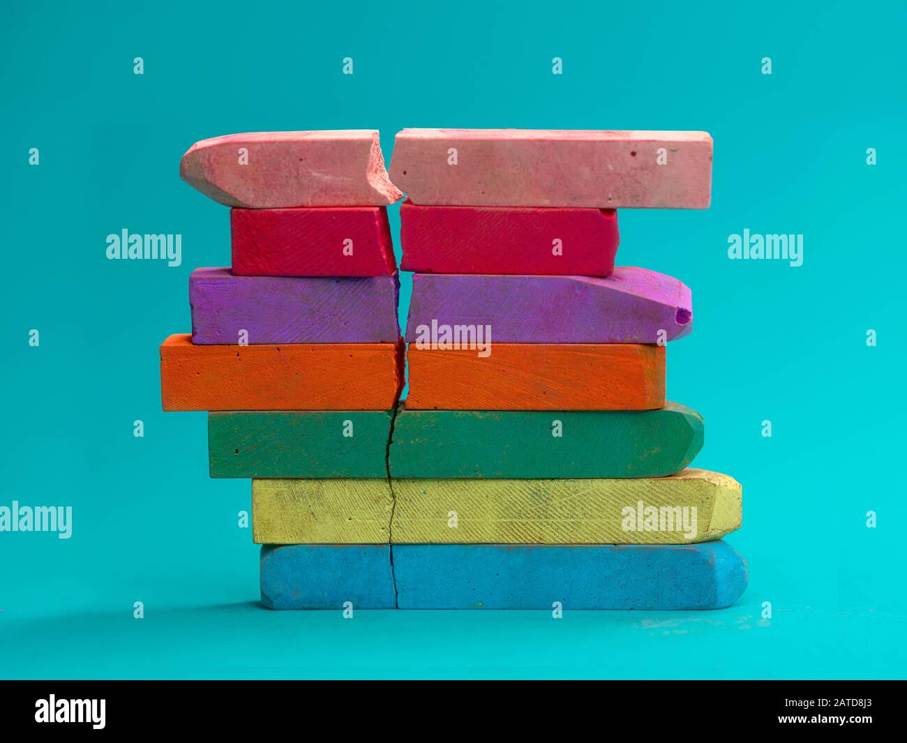 Stack of multi coloured chalk with a crack in Stock Photo - Alamy
