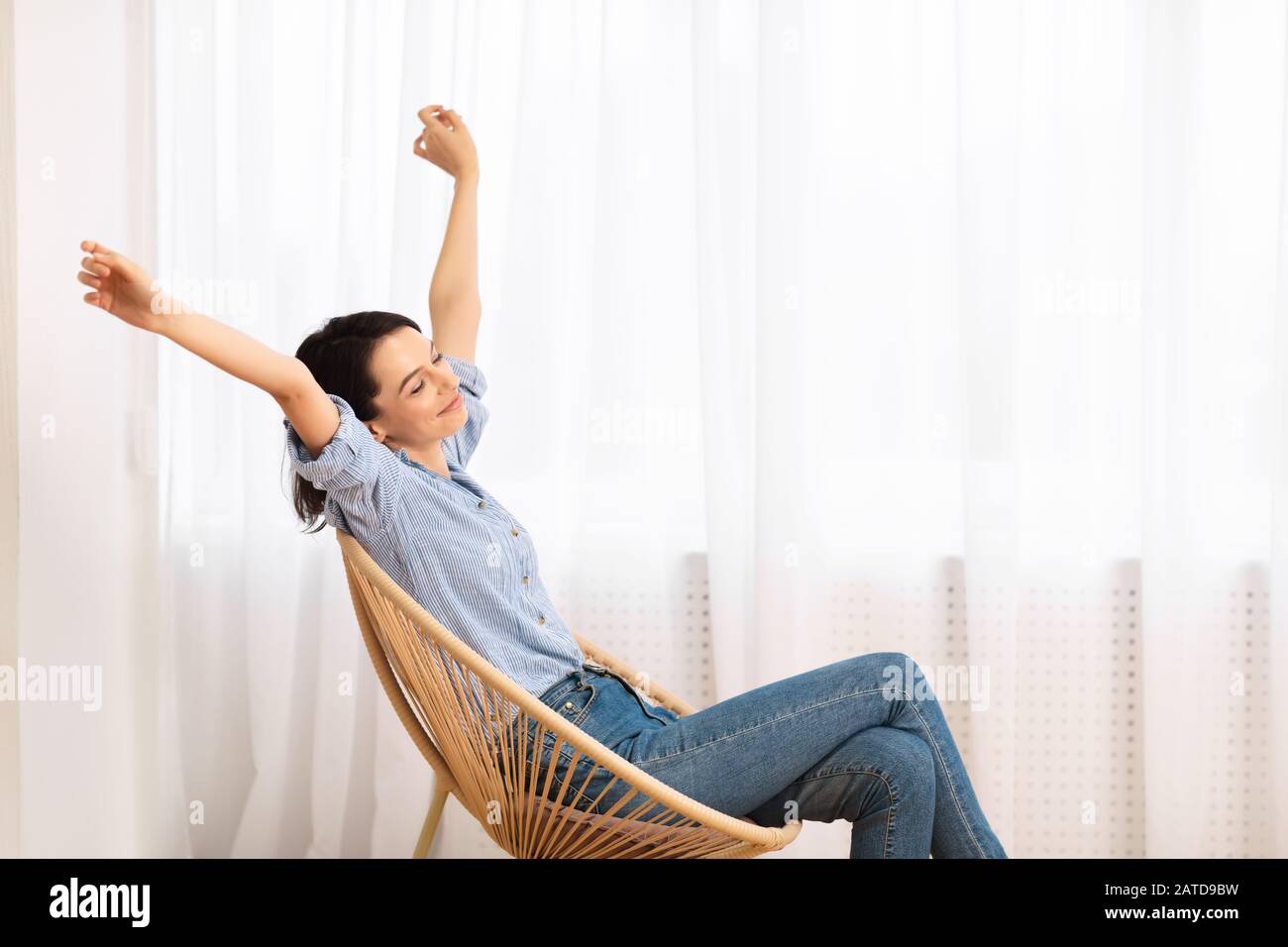 Girl having rest at home sitting in chair Stock Photo - Alamy