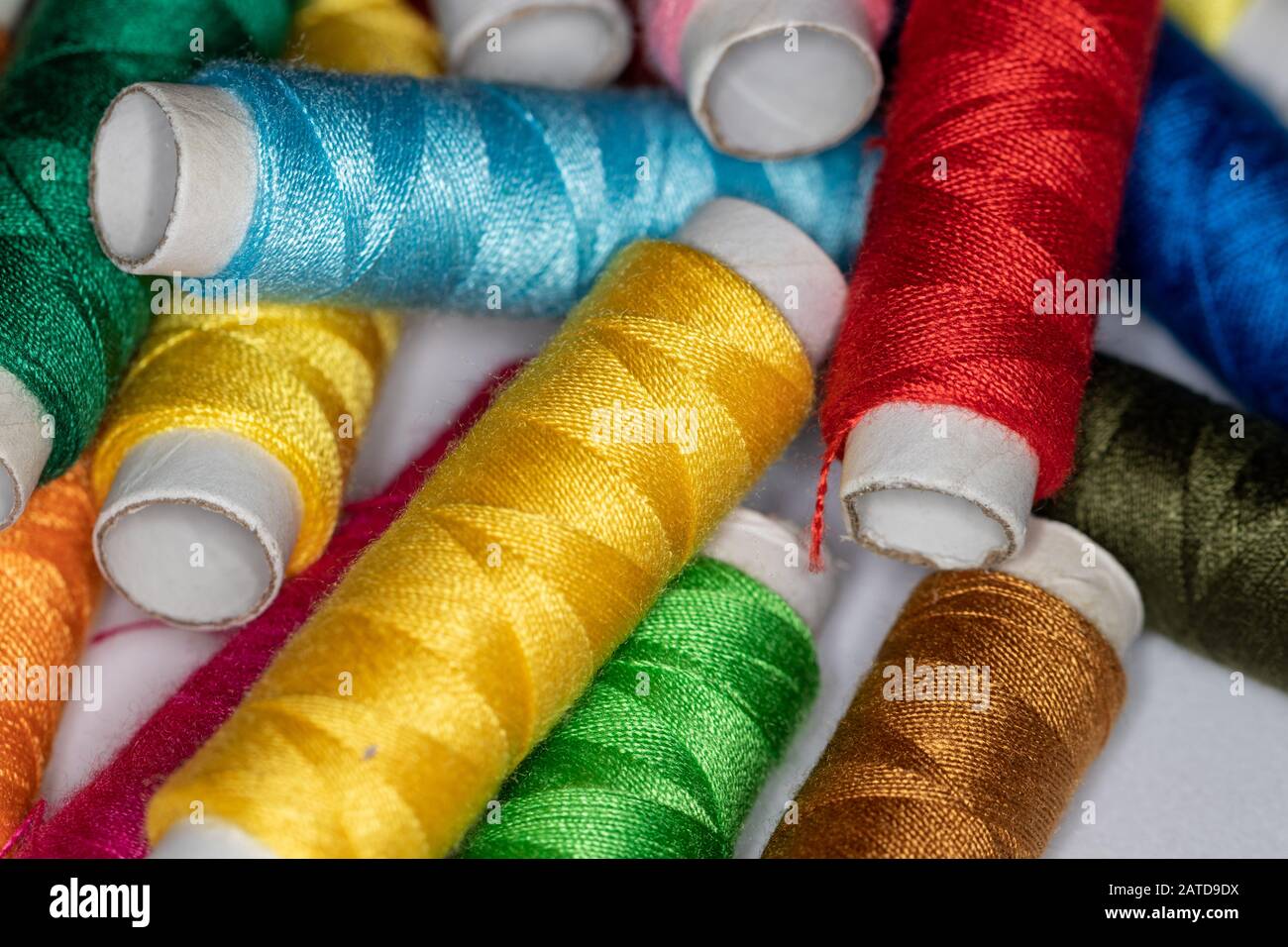 Very colorful sewing thread on cardboard cones Stock Photo - Alamy